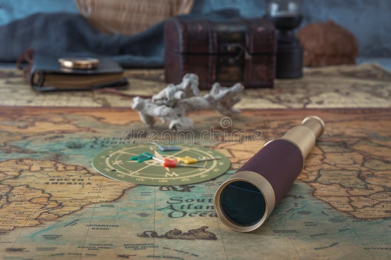 Spyglass, a Branch of Coral and Colored Markers Lie on an Old Map Stock ...