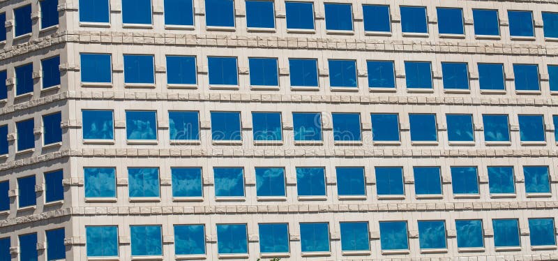 Blue Windows on Brown and Silver Curved Building Stock Photo - Image of ...