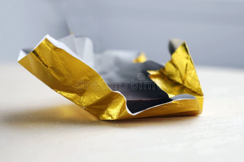 Chocolate in gold cover stock photo. Image of bitter - 110406786
