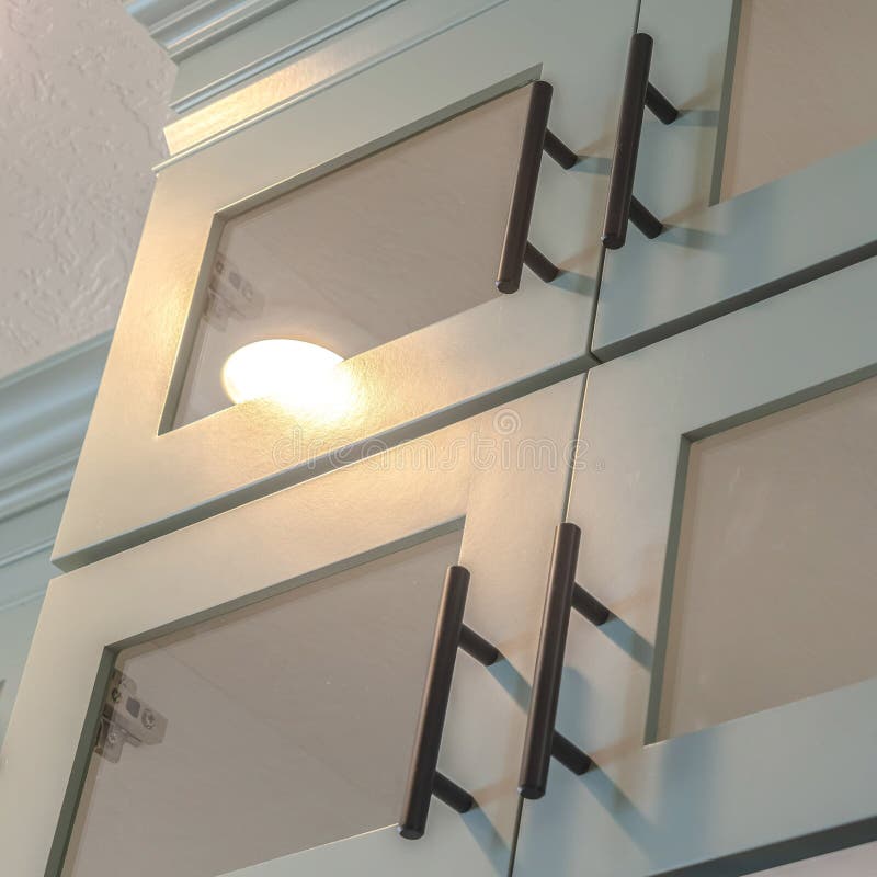 Square Close Up of Overhead Kitchen Cupboards and Handles Stock Photo ...