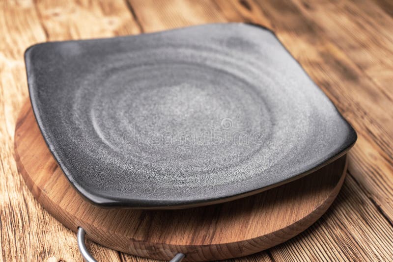 Square Concrete Plate on a Round Wooden Board. Close-up Stock Image ...