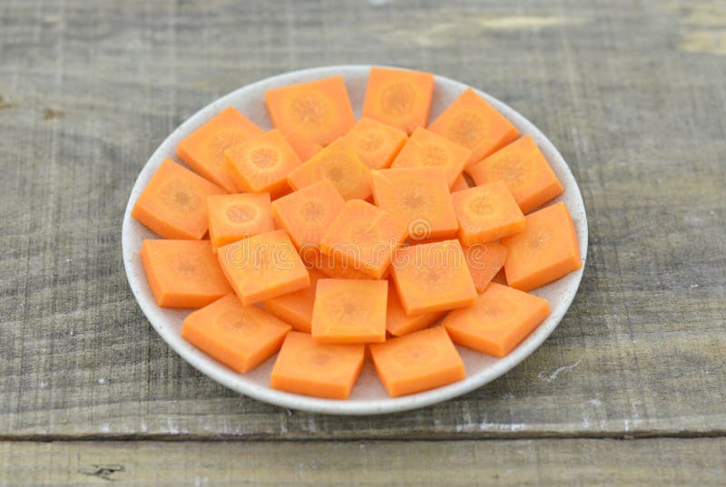 Square Cuts of Carrots on Wooden Rustic, Closeup Stock Photo - Image of ...
