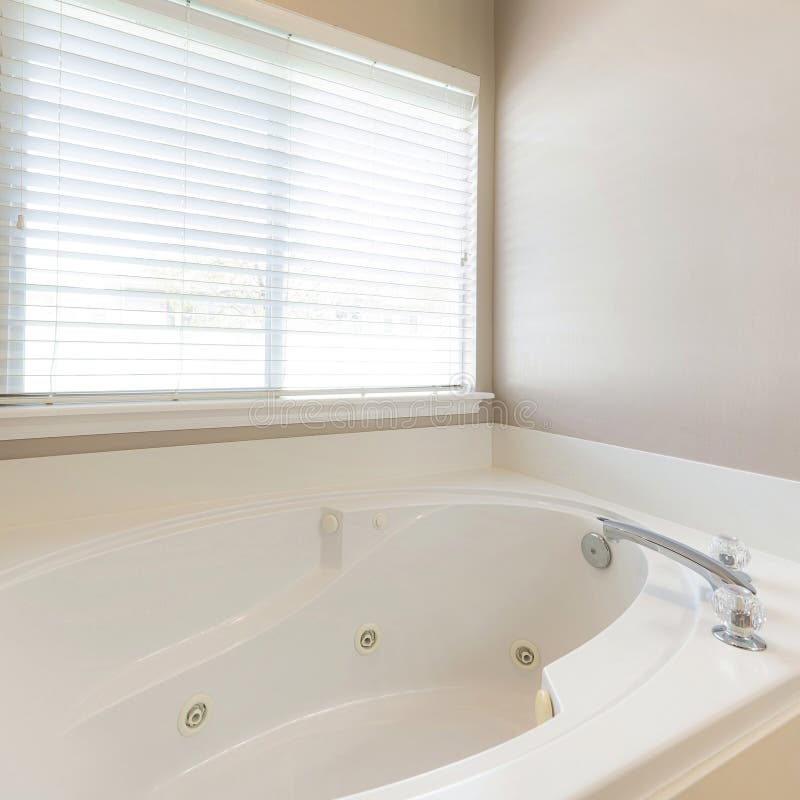 Square Drop-in Bathtub in a Bathroom with Windows and Blinds Stock ...