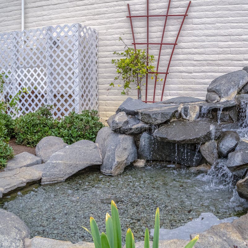 Square Artificial Stone Cascade Waterfall in Backyard on a Sunny Day ...