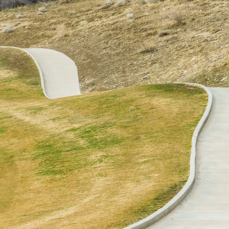 Square Frame Close Up of a Paved Pathway Running through the Slope of a ...