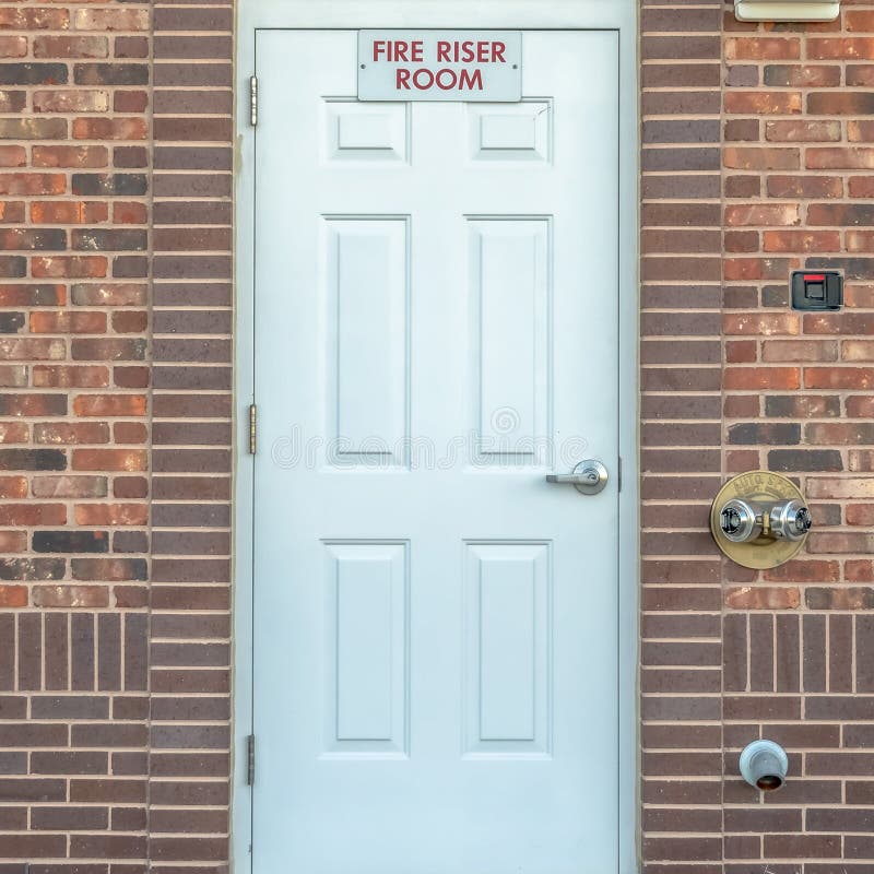 Fire Riser Room Sign on the White Wood Door of a Building with Red ...