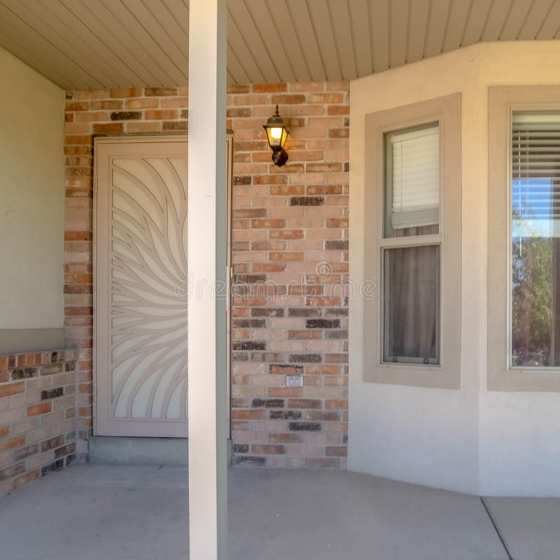 Square Frame Home Facade with Bay Window and Front Porch Supported by ...