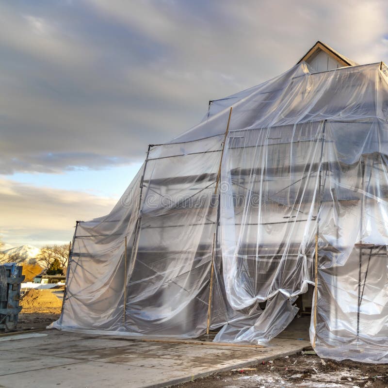 Square Frame House Under Construction Covered with Plastic Against ...