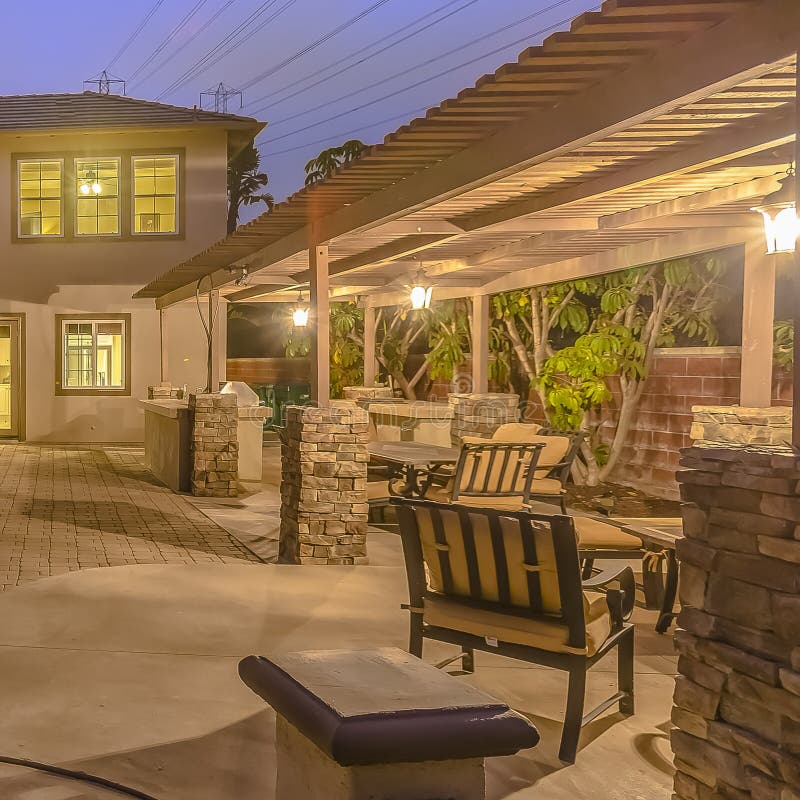 Square Frame Illuminated House with a Patio Accomodating an Outdoor ...