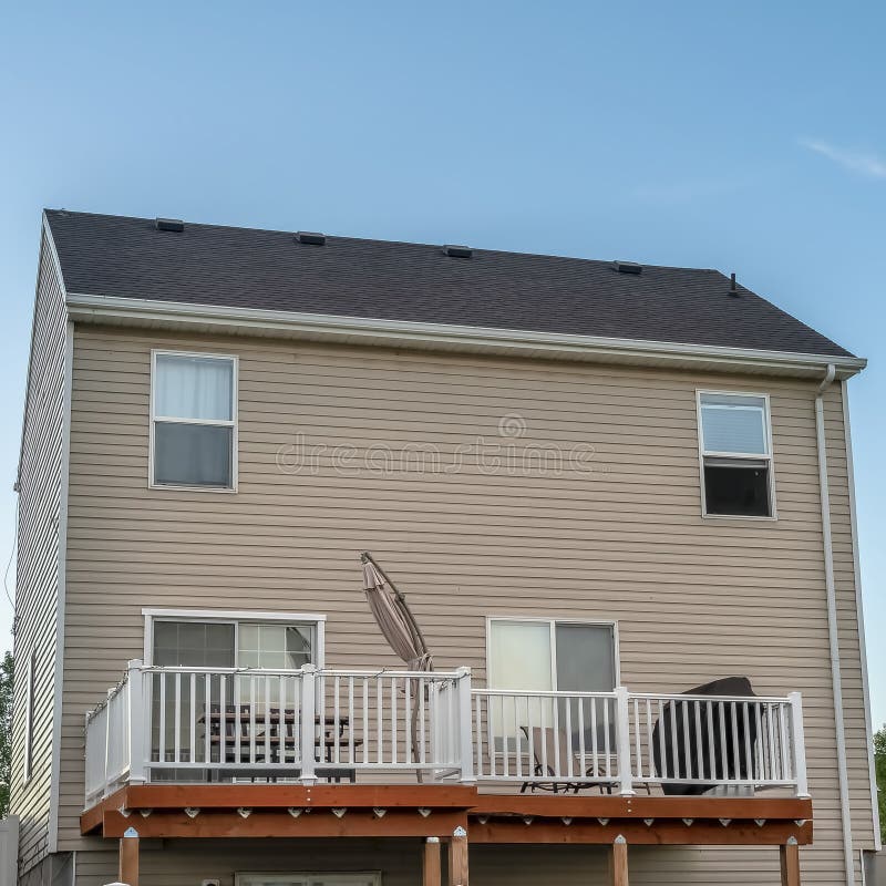 Square Home Featuring White Horizontal Wall Siding and Balcony Viewed ...