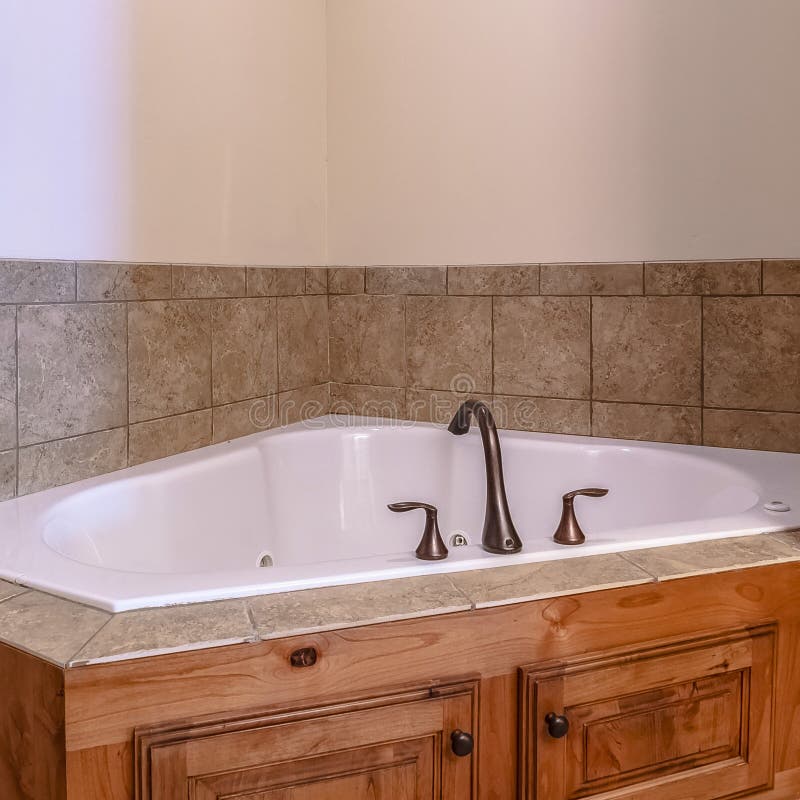 Square Interior of a Modern Bathroom with Corner Bath Stock Photo ...