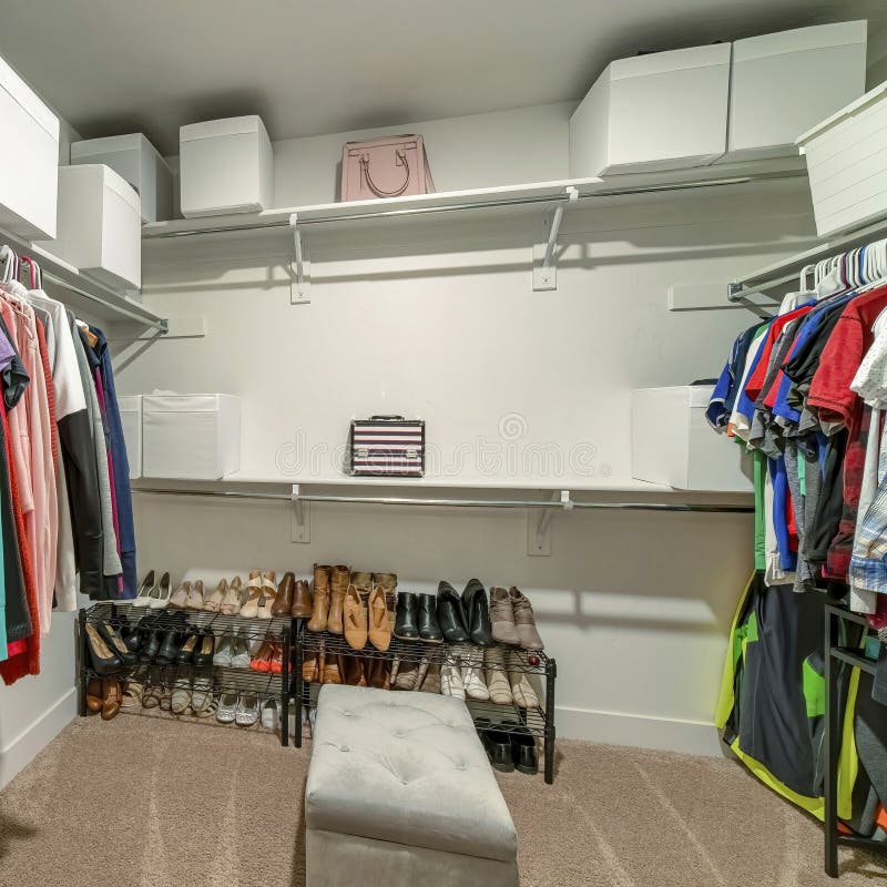 Square Interior of a Walk in Closet with Ottoman and White Storage ...