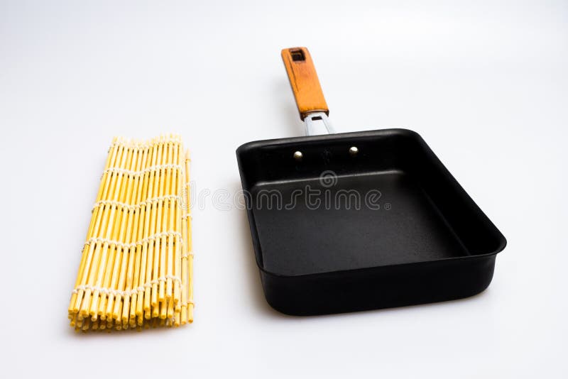 Square Japanese Frying Pan and Sushi Mat Stock Image - Image of ...