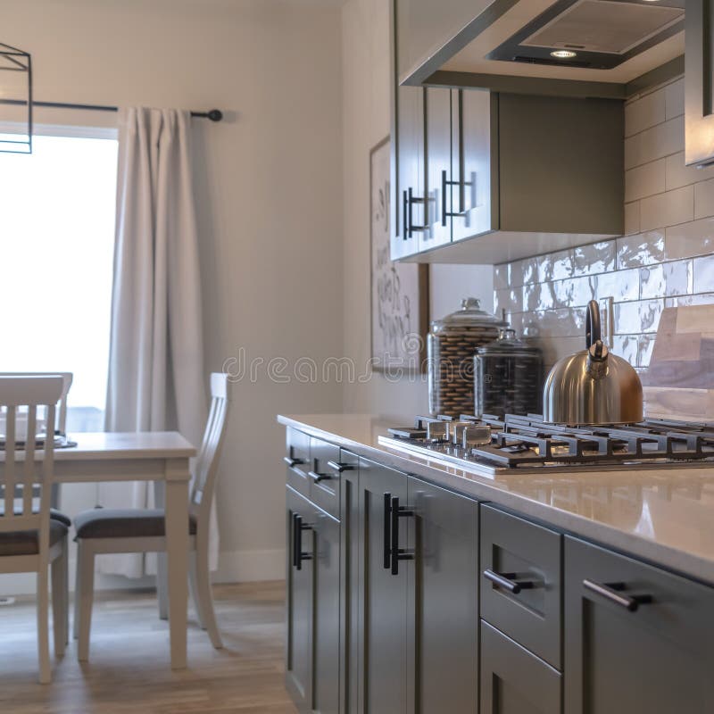 Square Kitchen Work Area with Cabinets Cooktop Countertop and Tile ...