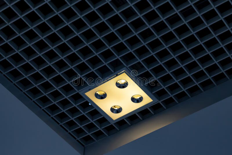 Square Lighting Fixture with Four Lamps on the Ceiling of an Commercial ...