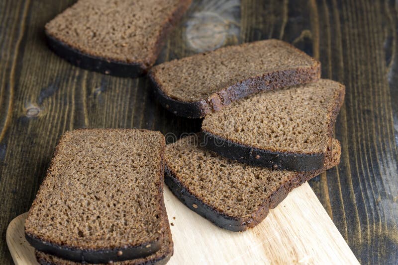Square Loaf of Black Rye Bread Cut into Pieces Stock Photo - Image of ...