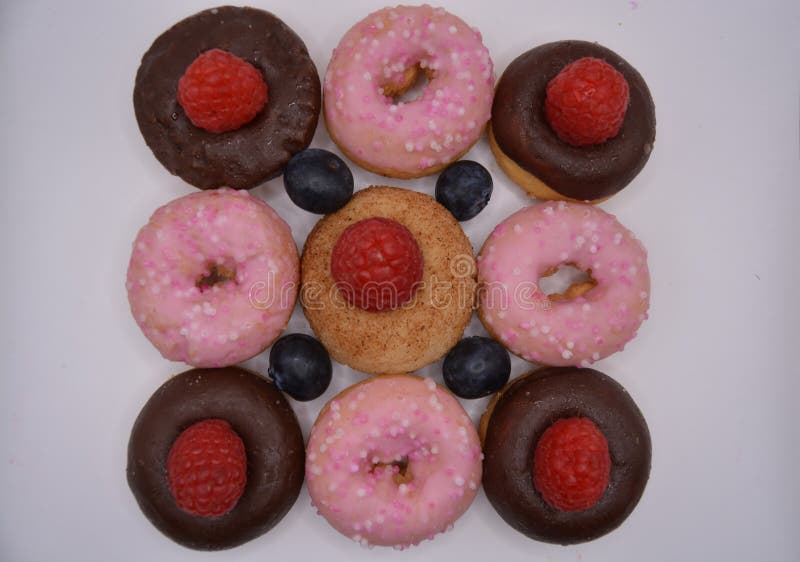 A Selection of Fresh Doughnuts and Berries Stock Photo - Image of snack ...