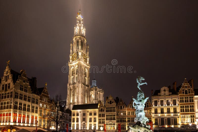 Square with People Walking Around and a Clock Tower in the Background ...