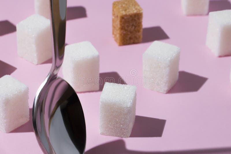 Square Pieces of Cane Sugar and a Metal Spoon on a Pink Background ...