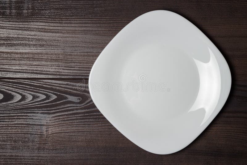 Empty Square Plate on Wooden Table with Fork and Spoon Stock Photo ...
