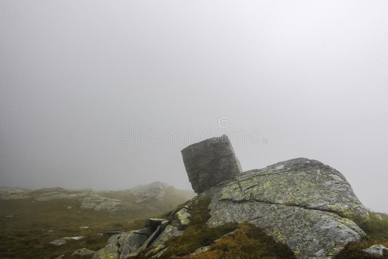 Square Rock on the Top from a Mountain while Hiking at Dense Fog Stock ...