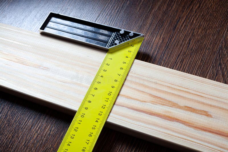 Square Ruler and Pencil for Measuring on Wooden Board. Construction ...