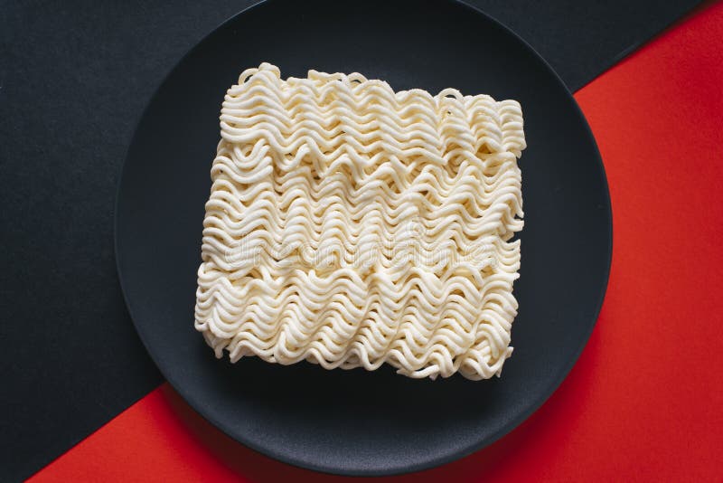 Square Shape Instant Noodles Over Red and Black Background Stock Photo ...