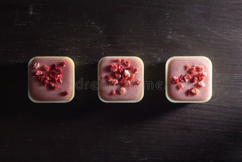 Square Shaped Strawberry Candies on a Wooden Table. Stock Image - Image ...