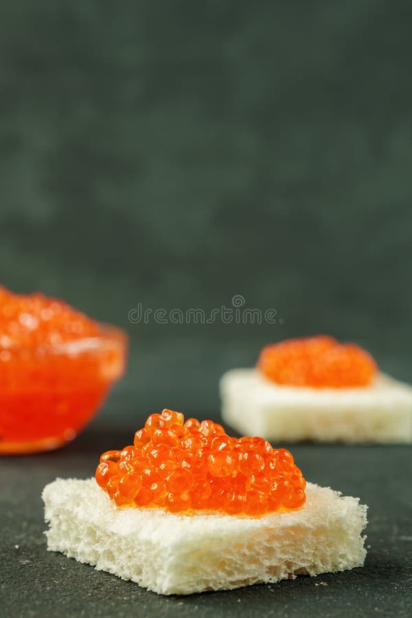 Square Shaped Wheat Bread with Red Caviar on Gray Background Stock ...