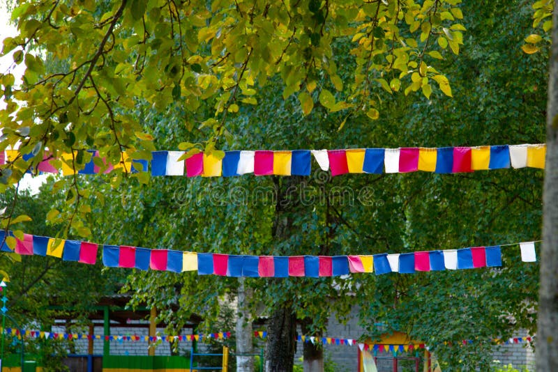 Square Small Flags of Red, White, Yellow, Blue are Hanging on a Rope ...