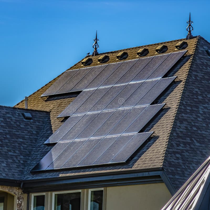 Square Solar Panels on Roof of Home with Lake and Snowy Mountain ...