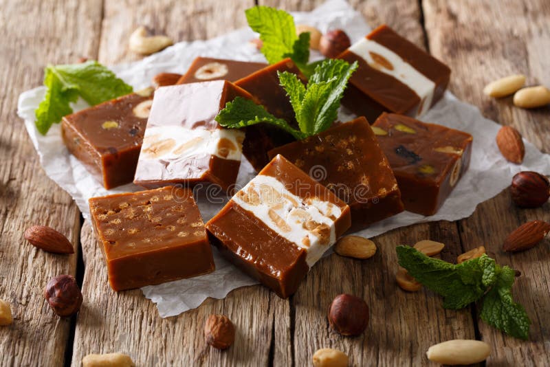 Square Sweets Toffee with Nuts Decorated with Mint Closeup. Horizontal ...