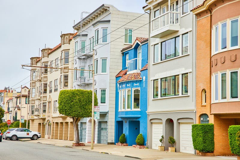 Squat Blue House with MMMM Above Windows between Closely Compact Row of ...