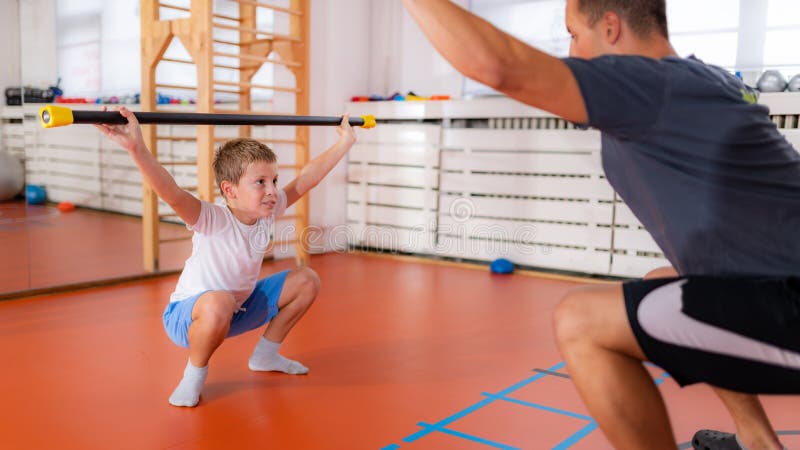 Squats with a Bar, Strength Training and Exercise for Children Stock ...