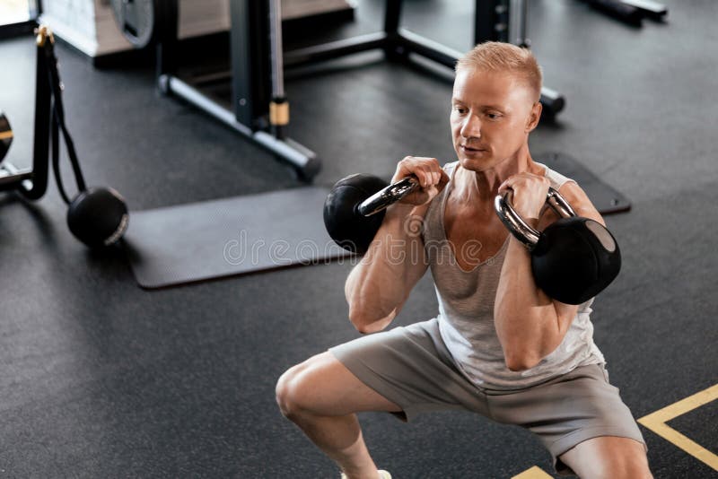 Squats with Kettlebells Exercise. Middle Aged Athlete Doing Functional ...