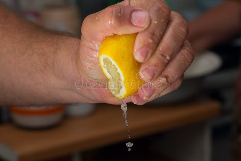 Squeeze Lemon Juice on Hand Stock Photo - Image of close, food: 74451368