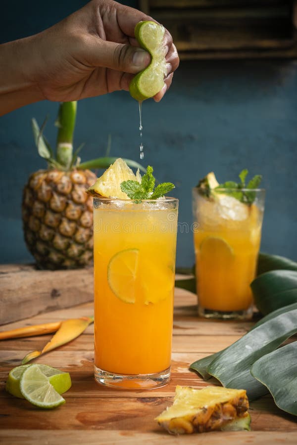 Squeeze Lime into a Refreshing Pineapple Mojito Cocktail. Stock Photo - Image of fresh ...