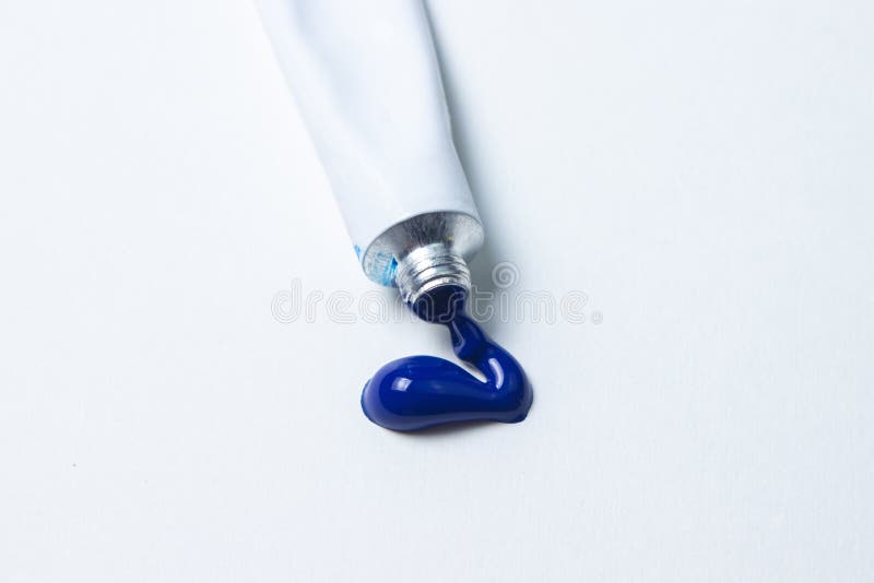 Squeeze Out a Tube of Blue Paint on a White Background. Stock Photo ...