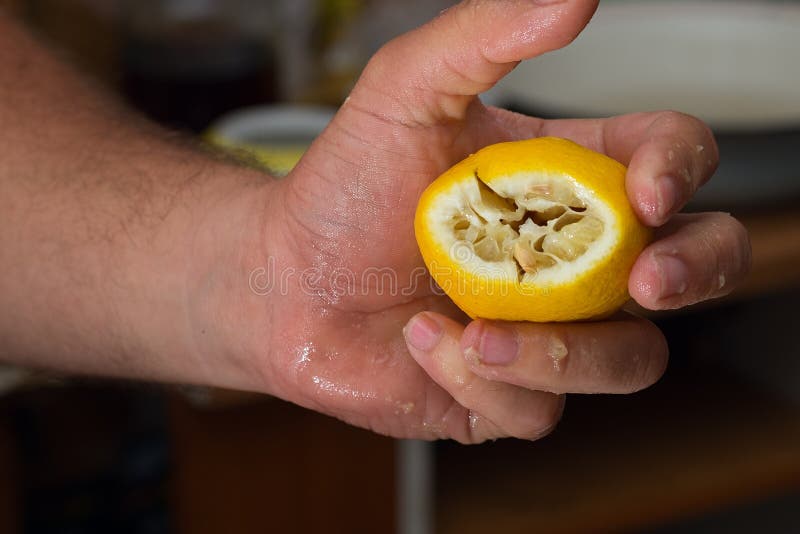 Squeezed lemon on hand stock photo. Image of splash, juicy - 74451278