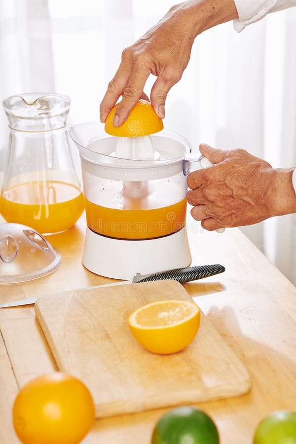 Squeezing orange juice stock image. Image of refreshing - 178135227