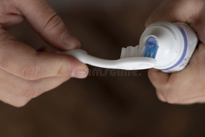 Personal Hygiene With Hands Squeezing Toothpaste On The Toothbrush ...