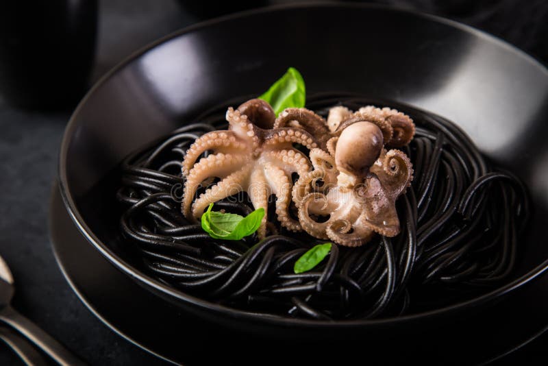 Black Squid Ink Spaghetti Pasta with Octopuses in Black Bowl Stock ...