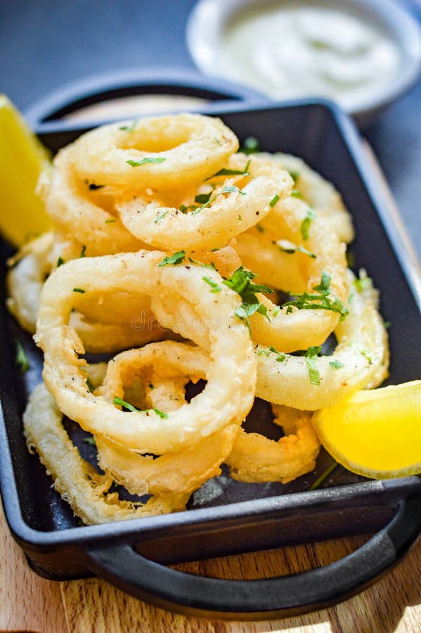 Squid Rings Deep Fried with Lemon Wedges Stock Photo - Image of close ...