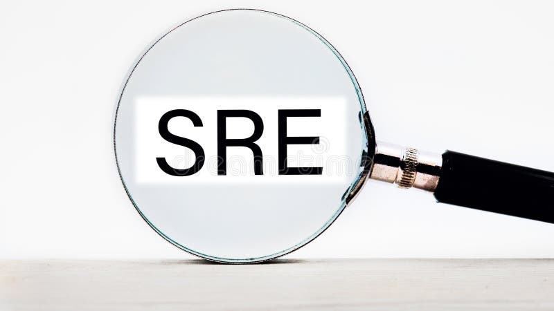 SRE. Site Reliability Engineering Lettering on through a Magnifying ...