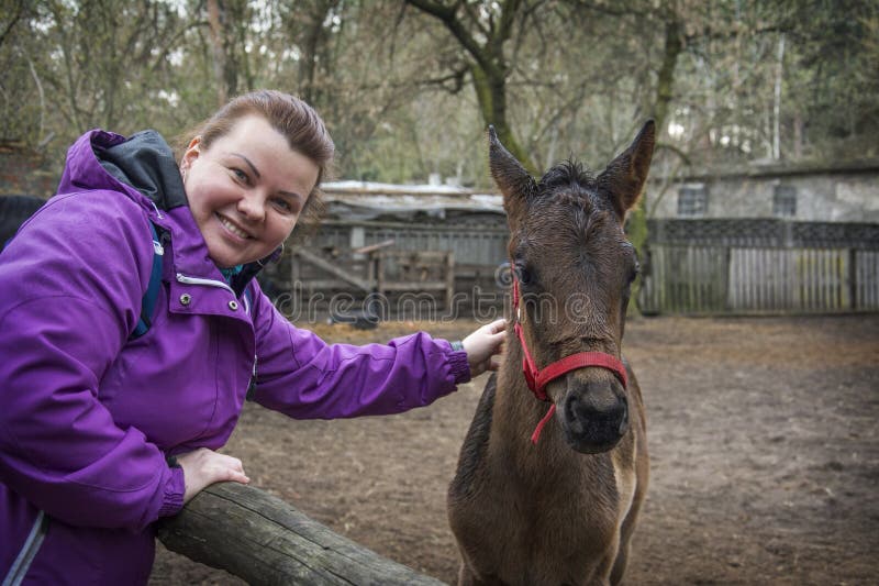 At the Stable, a Happy Girl Hugs a Foal Stock Image - Image of equine ...