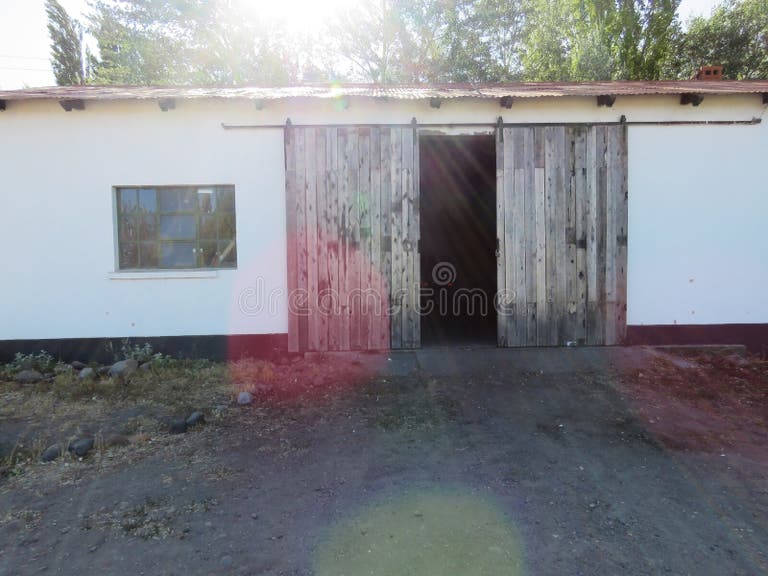 Stable with Open Gate. Sun Rays Forming Iridescence Stock Photo - Image ...