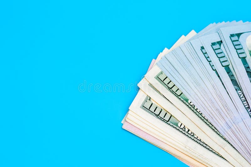 Stack of American Dollar Bills on Blue Background. Stock Photo - Image ...