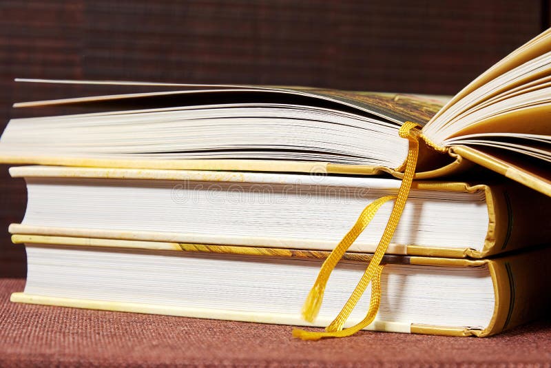 Stack of Ancient Books with One Opened Book Above the Heap on the ...