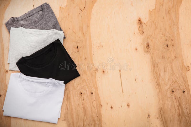 Stack of Arranged Different Coloured Mens T-shirt on Wooden Background ...
