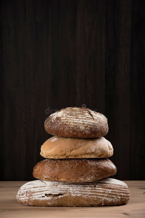 Artisanal Bread Loaves Stacked on Table Stock Image - Image of fiber ...